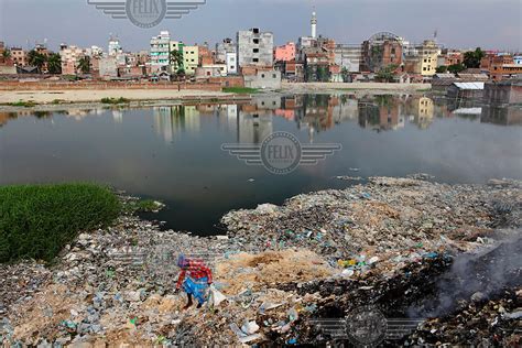 Man Throwing Garbage In The River