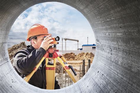 Surveyor Engineer Is Measuring Level On Construction Site Surveyors