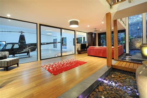 Chris Clout Design hangar home in Whitsunday's with helicopter in house modern contemporary ...