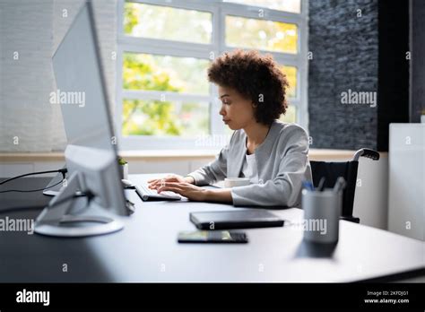 african american black woman using computer worker with disability
