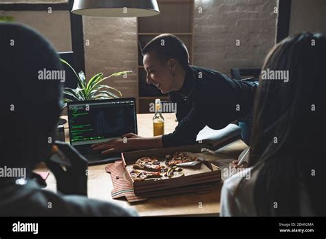 Female Computer Programmer Typing Over Laptop At Workplace Stock Photo Alamy