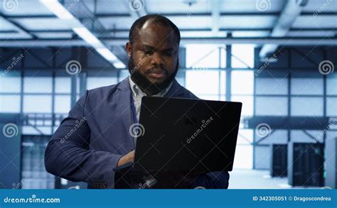 Computer Scientist In Data Center Using Diagnostic Tools On Laptop Stock Image Image Of