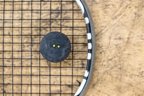 Premium Photo Close Up Of Squash Ball On Racket
