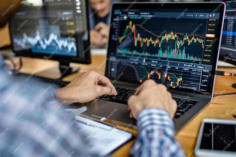 a man is working on a laptop with a graph showing the graph of graph premium ai generated image