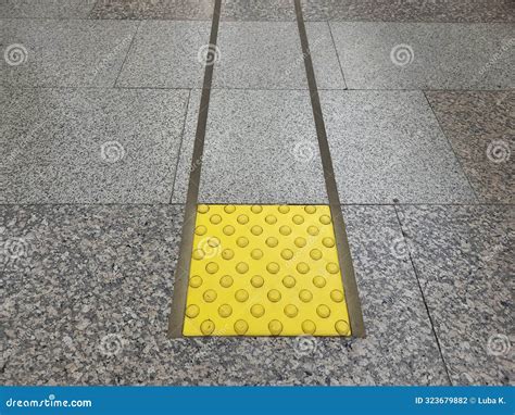 Yellow Tactile Tiles Are Installed On Outdoor Pedestrian Walkways To