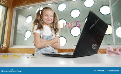 Smart Cute Girl Using Laptop Programing Software While Crossing Arms