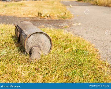 Broken Old Rusty Exhaust Pipe Park Laying On Grass Next To British Road