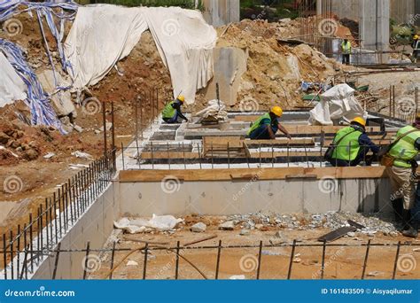Construction Workers Installing Fabricating Ground Beam Timber Form Works At The Construction