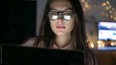 Woman In Glasses Looking On The Monitor And Working With Charts By
