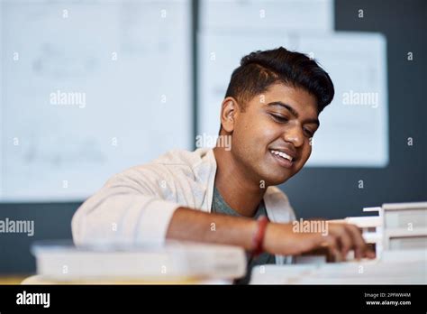 A Keen Eye For Architectural Design A Young Architect Designing A Building Model In A Modern
