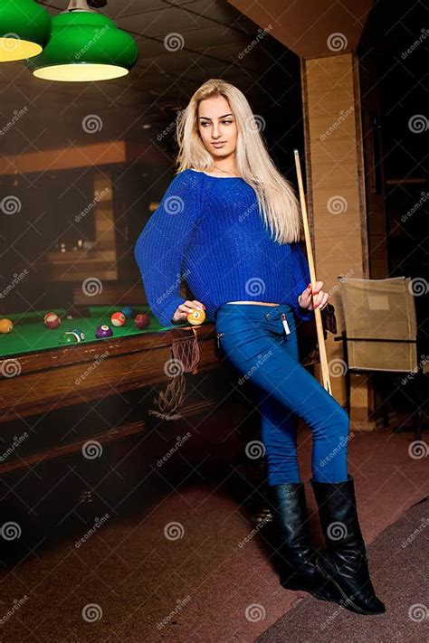 Young Sexual Woman Posing At Pool Table With The Cue In Hands Stock