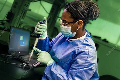 Researcher Preparing A Portable Sequencing Instrument Stock Image