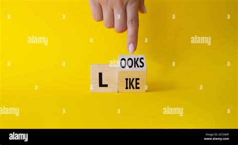 Looks Like Symbol Businessman Hand Points At Turned Wooden Cubes With