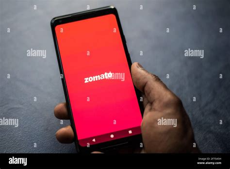 Zomato Food Delivery App On Android Smartphone Help By Asian Adult Man
