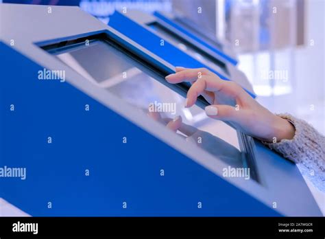 woman using interactive touchscreen display at technology exhibition