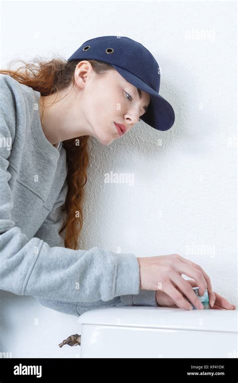 Female Contractor Repairing Flush Button On Toilet Stock Photo Alamy