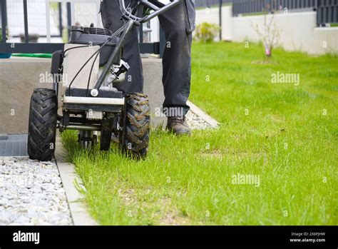 Gardener With Cable Laying Machine As Laying Aid For Perimeter Wire Of Lawn Robot Stock Photo