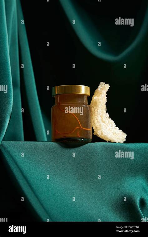 Raw Edible Bird Nest Beside A Glass Bottle Of Bird Nest Soup Unlabeled On Green Soft Fabric