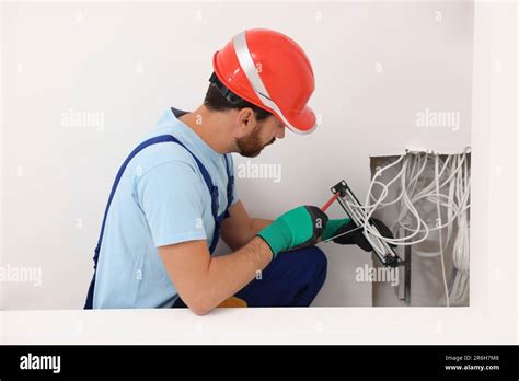 Electrician With Screwdriver Fixing Patch Panel Indoors Stock Photo Alamy