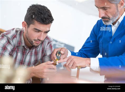Men Fixing Something Stock Photo Alamy