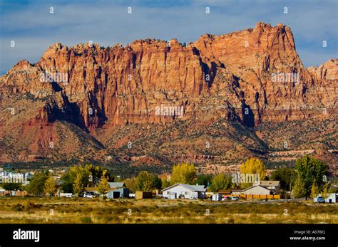 Homes Below Red Rock Cliffs And Butte At Colorado City Arizona Stock