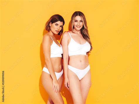 Fashion Portrait Of Two Young Beautiful Women Attractive Carefree