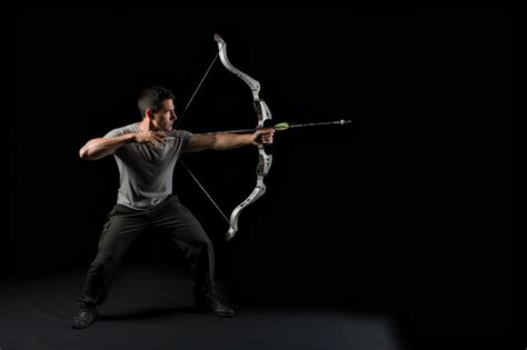 Premium Photo Man Practicing Archery With Bow And Arrow
