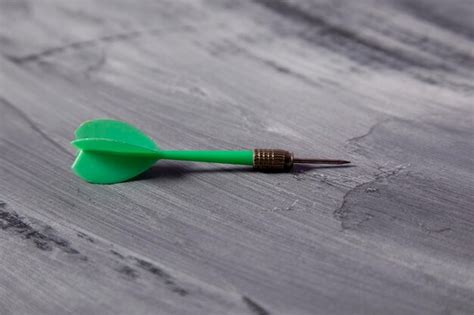 Premium Photo Dart On The Tableclose Up