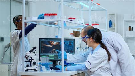 Team Of Microbiology Scientists Discussing About Virus Development In