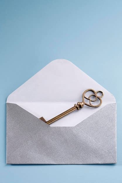 Premium Photo Close Up Of Key In Envelope Against Blue Background