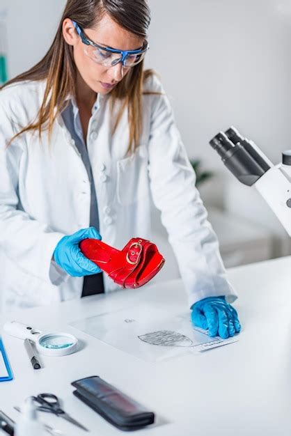 premium photo forensic science expert examining objects from a crime
