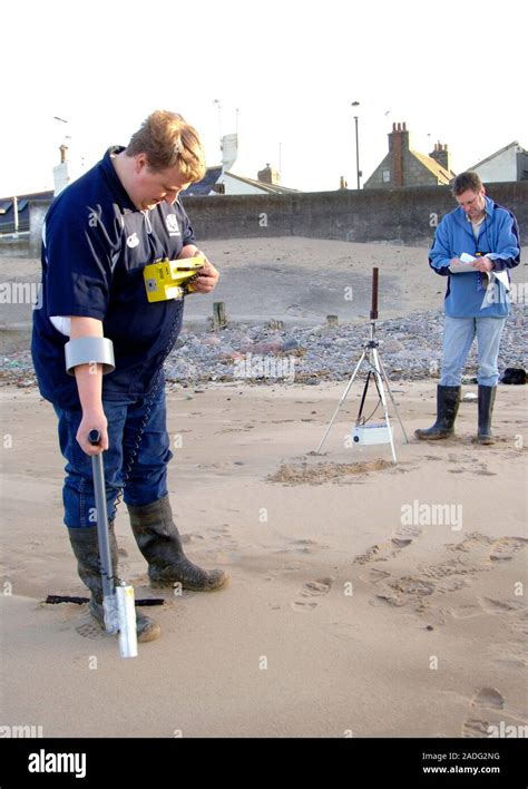 Coastal Radiation Monitoring Researchers Using Radiation Detectors On A Beach They Are