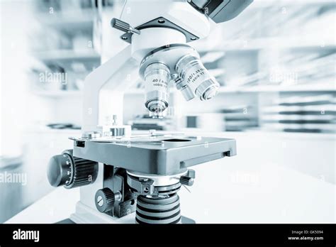Science Microscope On Lab Bench Microbiology Laboratory Blue Toned Science Microscope On Lab Bench Microbiology Laboratory Blue Toned