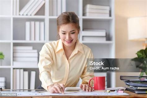 보고서를 준비하는 여성 직원의 초상화 사무실 책상에서 서류 작업을 하고 있다 25 29세에 대한 스톡 사진 및 기타 이미지 25 29세 검사 보기 계산기 Istock
