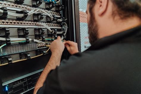 Premium Photo Close Up Of Technician Setting Up Network In Server Room