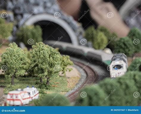 Exhibition Of Model Railways In Which A Renfe Locomotive Pulling Freight Wagons Exits A Curved