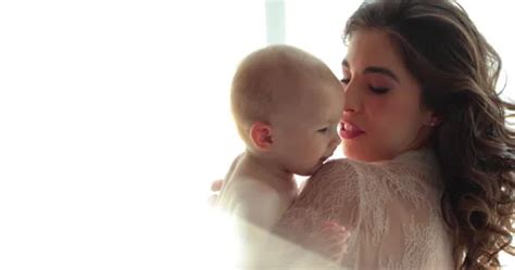 A Beautiful Mother Holds A Small Naked Stock Video Pond