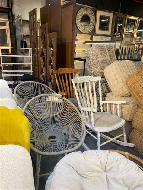 Many Chairs And Couches Are Stacked On Top Of Each Other In A Room