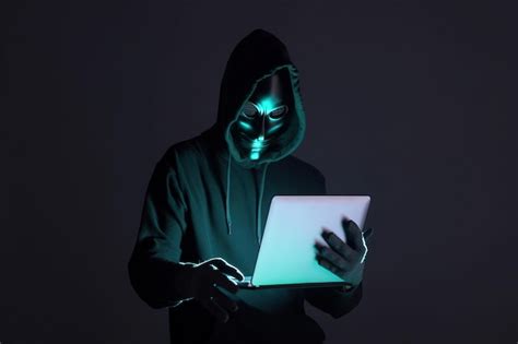 Premium Ai Image A Hacker In A Hoodie Using A Laptop Computer