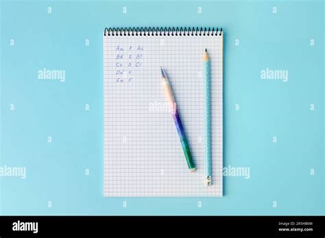 letters and numbers written in notepad with erasable pens on light blue