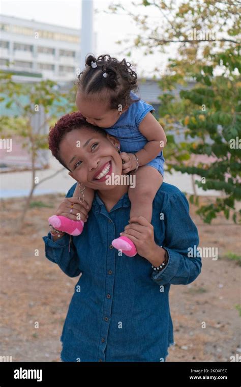 Optimistic Colombian Mother In Denim Shirt With Short Hair Smiling And