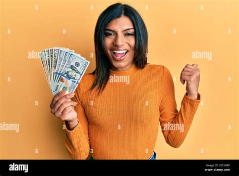 Young Latin Transsexual Transgender Woman Holding Dollars Pointing