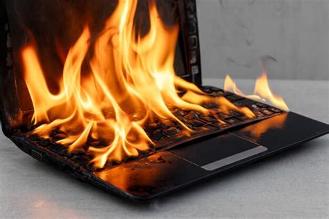 Premium Photo An Open Laptop Burning In A Fire Closeup