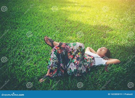 Young Woman Lying Down On Grass Stock Image Image Of Smiling