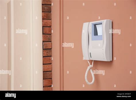 Modern Intercom System With Handset On Beige Wall Space For Text Stock