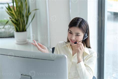 Close Up Call Center Operator In Wireless Headset Talking With Customer