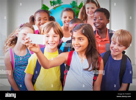 Composite Image Of Cute Pupils Using Mobile Phone Stock Photo Alamy