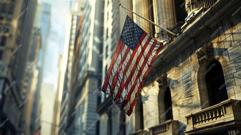 The American Flag Hanging From A Building Facade On Cityscape