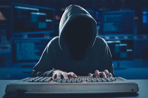 Premium Photo Hooded Unknown Programmer Typing On Keyboard