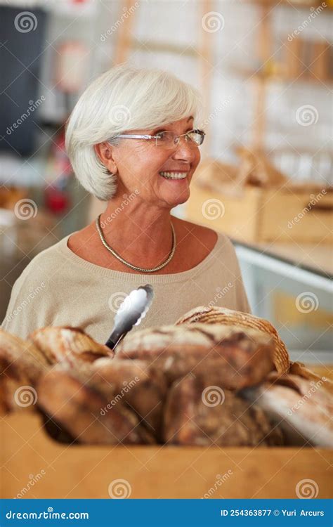 Shes Well Known For Her Delicious Breads A Happy Senior Woman Working In A Bakery Stock Image